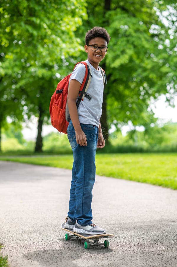 A Curly-haired Boy on a Longboard in the Park Stock Image - Image of ...