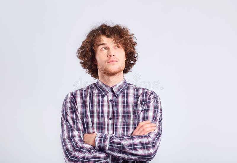 A Curly-haired Guy Thinks with a Serious Emotion. Stock Image - Image ...