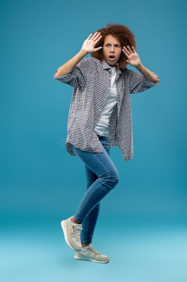 Curly-haired Woman Looking Scared and Running Away Stock Photo - Image ...