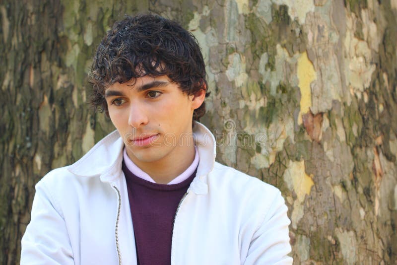 Curly Haired Young Adult Man in White, with a Tree Stock Photo - Image ...