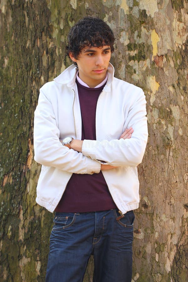 Curly Haired Young Adult Man in White, with a Tree Stock Image - Image ...
