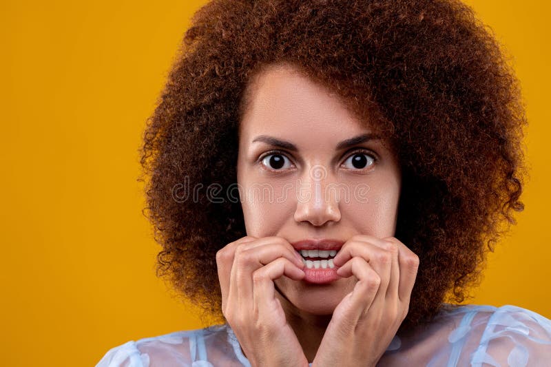 Curly-haired Young Woman Looking Uncretained and Infance Stock Photo ...