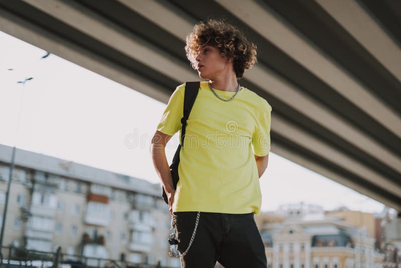 Curly Young Man Putting Hands Behind His Back Stock Image - Image of ...