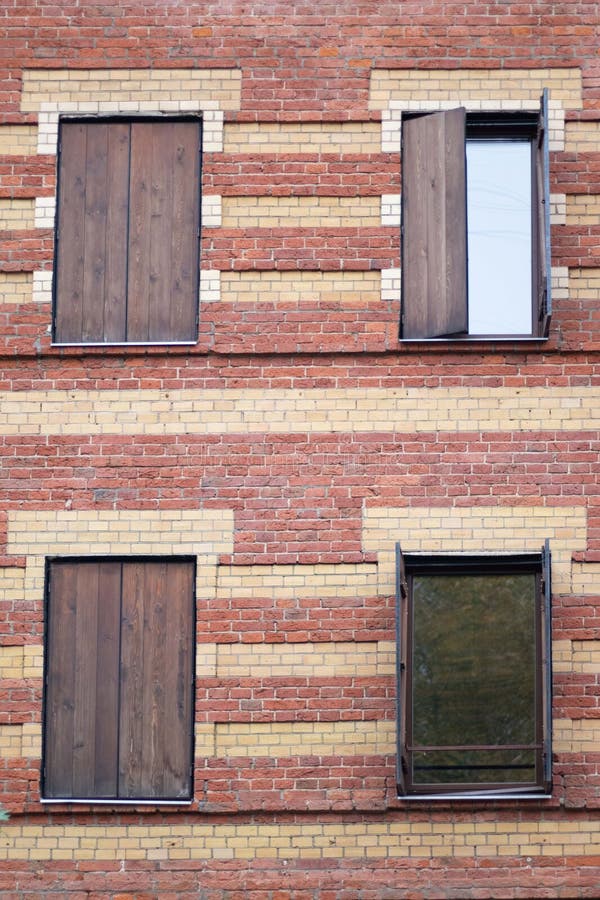 Red and Yellow Brick Wall with Four Windows, Two Open and Two Closed ...