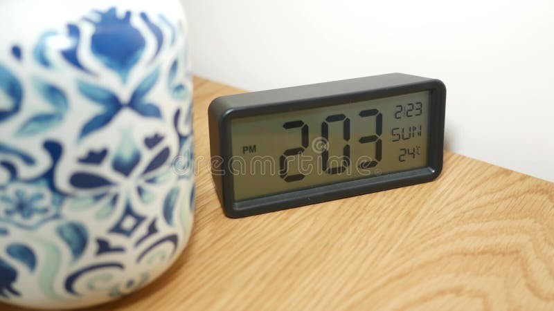 Current Time Displayed on a Digital Clock with Decorative Vase Stock ...
