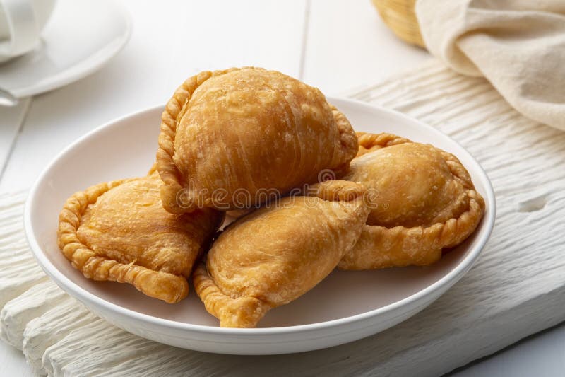 Curry puff in white plate stock photo. Image of detail - 281322096