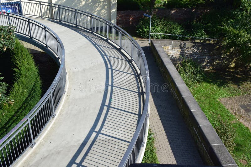 A curved pedesrian bridge stock photo. Image of town - 336343236