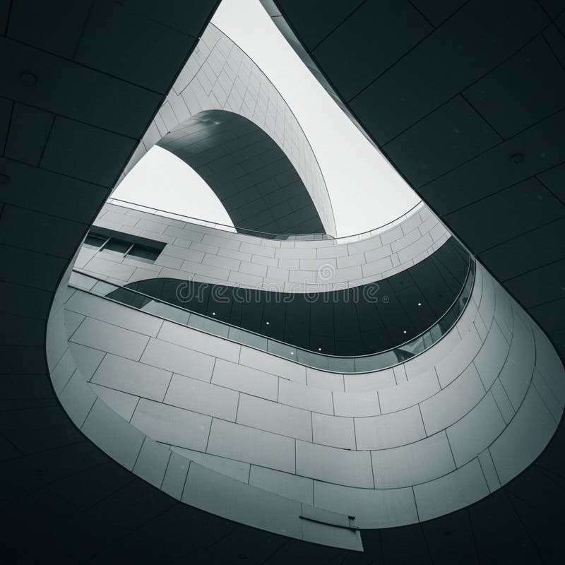 Curved Architectural Structure Featuring Smooth, Gray Panels Forming a ...