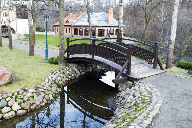 Curved bridge over stream stock photo. Image of architecture - 232245874