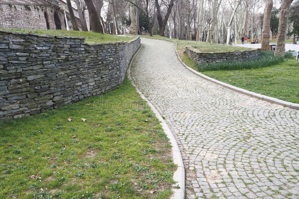 Curved Cobblestone Pathway in a Tranquil Park Setting Stock Photo ...