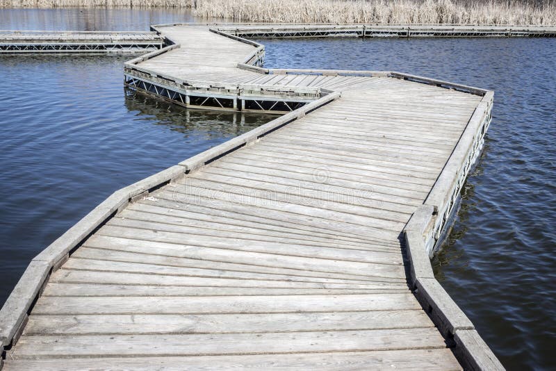 Curved Floating Walking Bridge Over a Lake. Stock Image - Image of ...