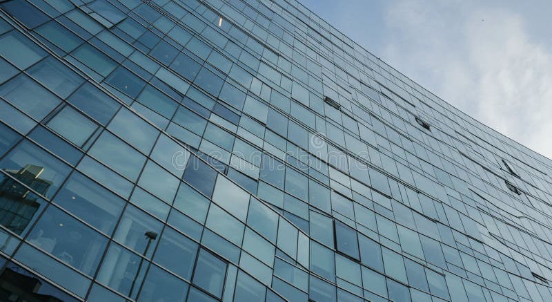 Curved Glass Facade of a Modern Skyscraper, Featuring a Grid-like ...