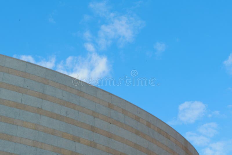 Curved Lines and Horizontal Stripes in Light Stone Against Blue Sky ...