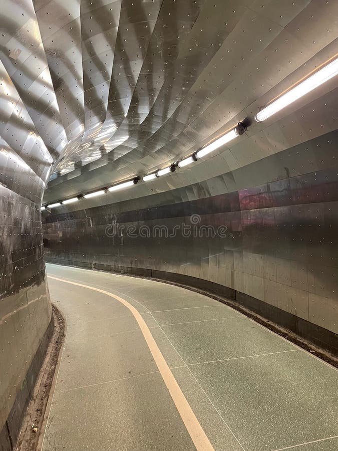 Curved Metallic Tunnel with Overhead Lighting. Stock Image - Image of ... Curved Metallic Tunnel with Overhead Lighting. Stock Image - Image of ...