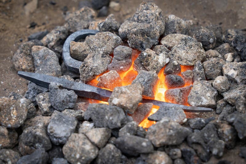 Piece of Wrought Iron between Glowing Coals in a Forge Stock Photo ...