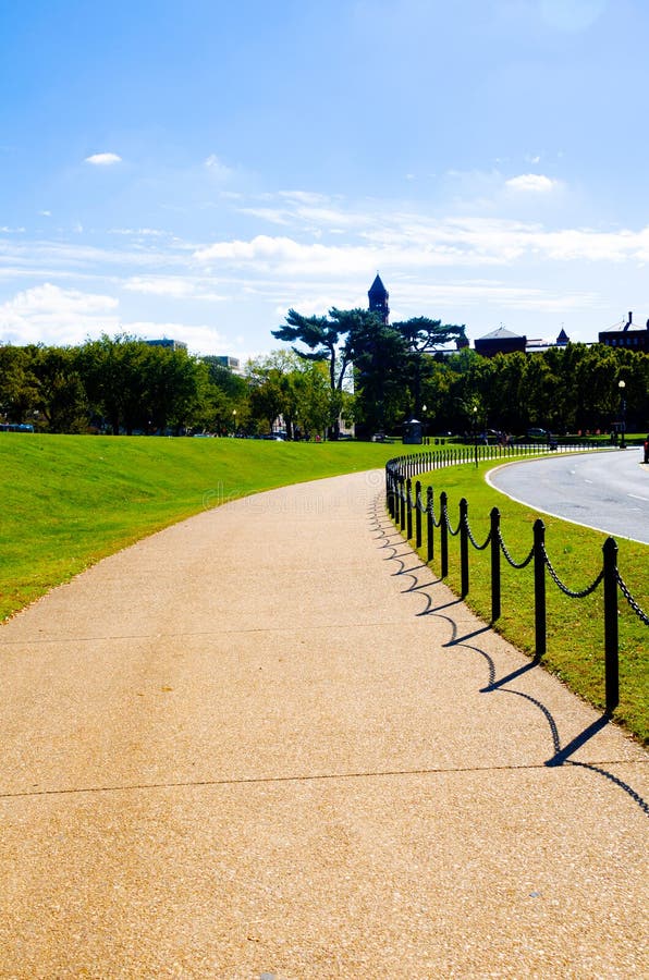 Curved Walkway with Smooth, Tan Concrete Surface Winds through a Park ...