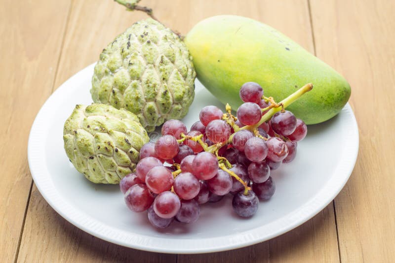 Custard Apple Mango and Red Grape in White Dish Stock Photo - Image of ...