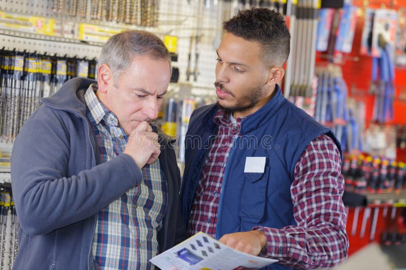 Customer Being Advised by Shop Assistant in Hardware Store Stock Image ...