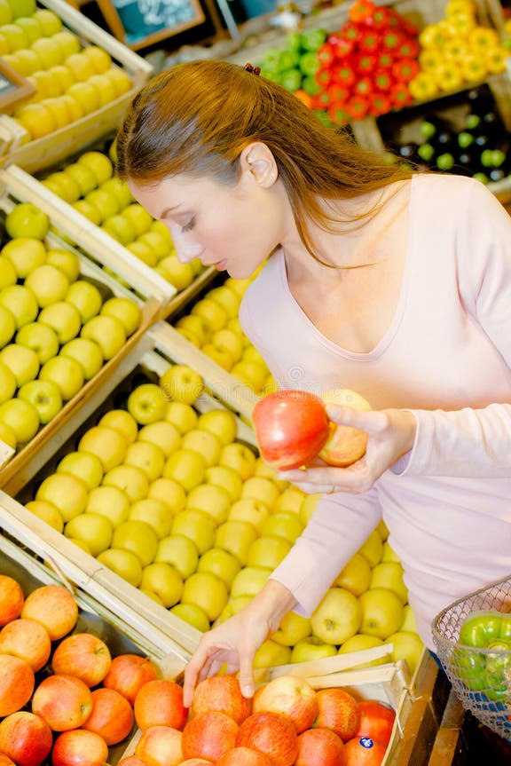 Customer choosing fruit stock image. Image of organic - 315450099