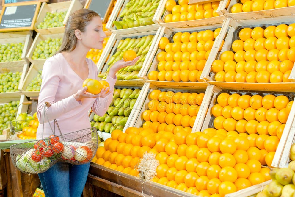 Customer choosing oranges stock photo. Image of hands - 338943706