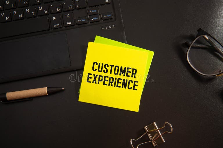CUSTOMER EXPERIENCE Text on the Sticker with Pen on Black Background ...