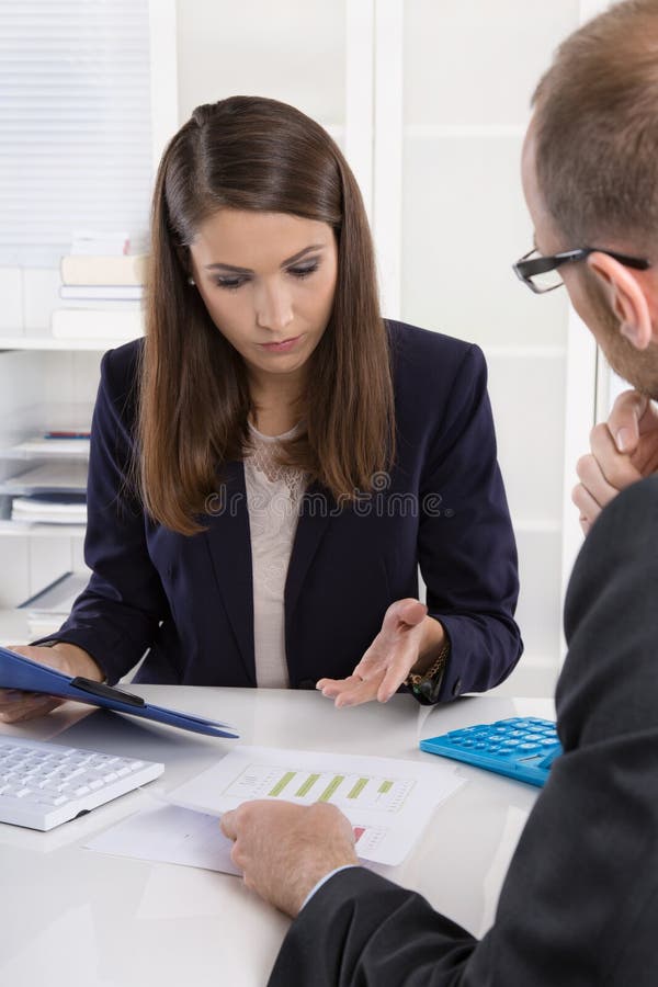 Customer and Female Financial Agent in a Discussion at Desk. Stock ...