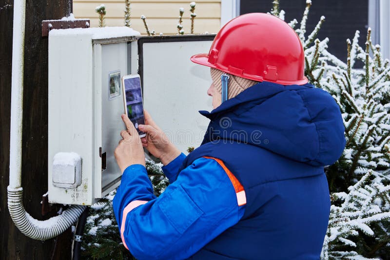 Customer Field Representative Inspects an Electricity Meter for a ...