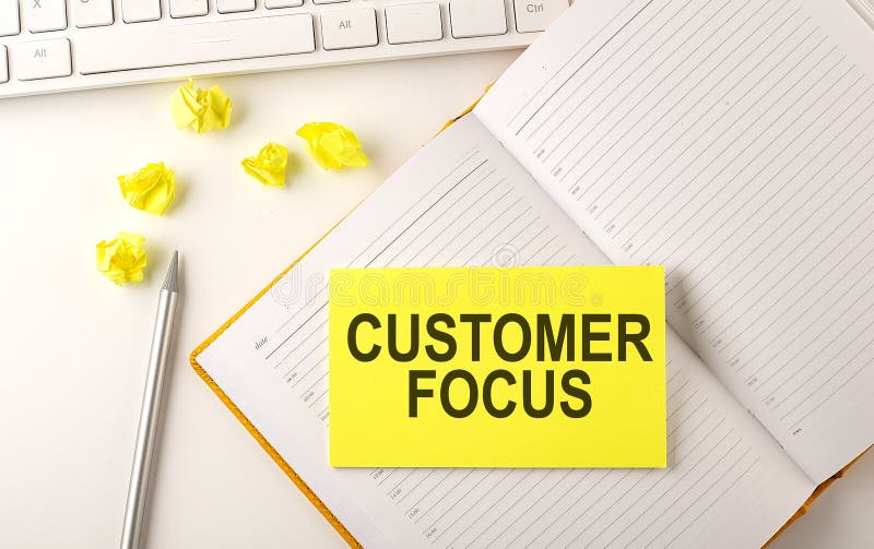 CUSTOMER FOCUS Text on the Sticker on the Diary with Keyboard and ...