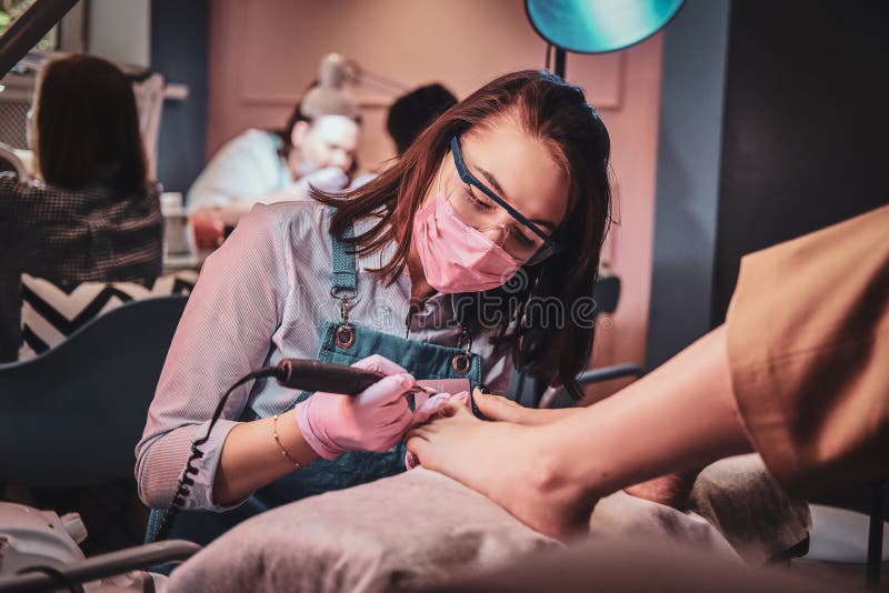 Customer is Getting Good Service from Diligent Nail Master. Stock Photo ...