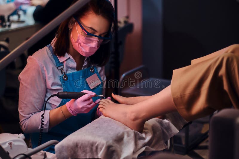 Customer is Getting Good Service from Diligent Nail Master. Stock Photo ...