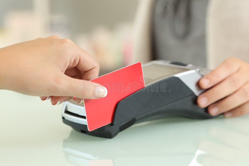 Customer Hand Passing Credit Card through the Reader Stock Image ...