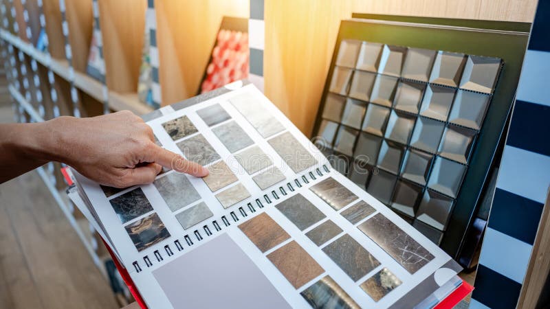 Customer Hand Pointing at Sample of Stone Tile Swatch Collection in ...