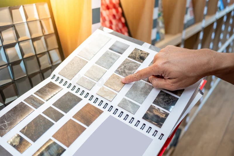 Customer Hand Pointing at Sample of Stone Tile Swatch Collection in ...