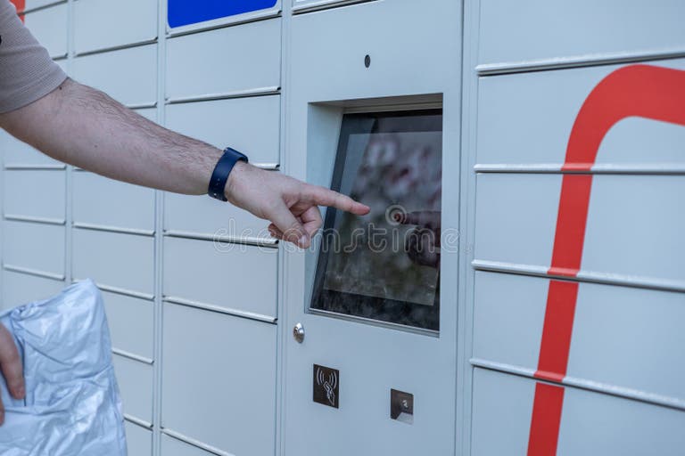 Customer Hand Touching Touchscreen Interface on Automated Parcel Locker ...