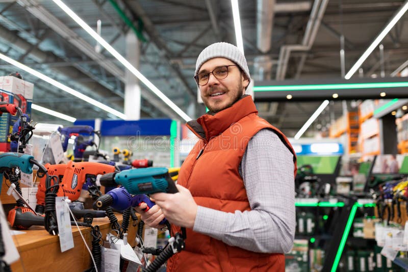 Customer in a Hardware Store Next To a Showcase with Power Tools Stock ...