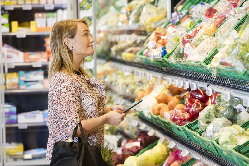 Customer Holding Digital Tablet while Looking at Vegetables Stock Image ...