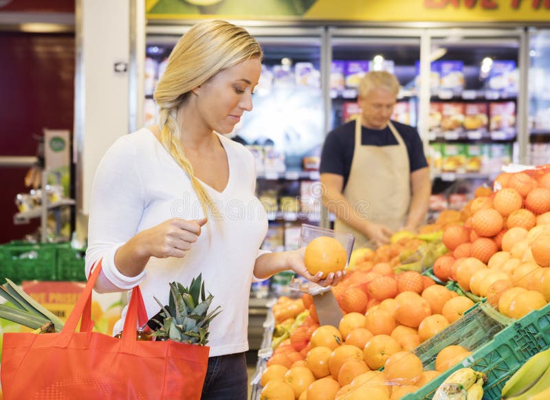 Customer Holding Orange in Grocery Store Stock Image - Image of ...