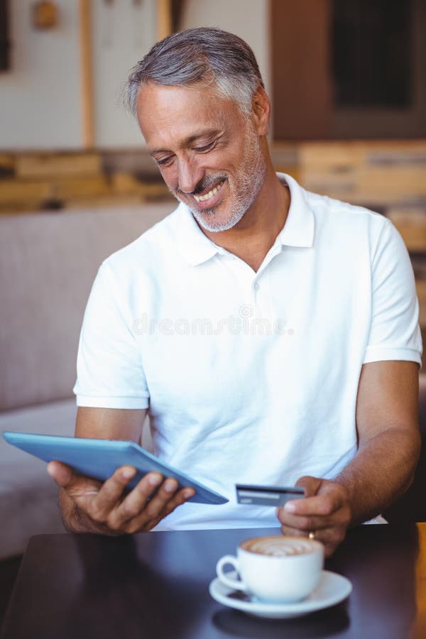 A Customer Holding Tablet and Credit Card Stock Photo - Image of ...