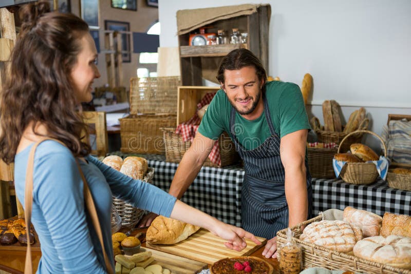 Smiling Customer Receiving a Parcel from Staff at Counter Stock Image ...