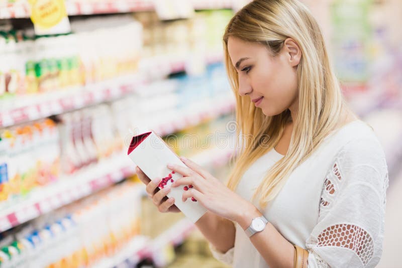 Customer Looking at a Bottle of Fruit Juice Stock Photo - Image of ...