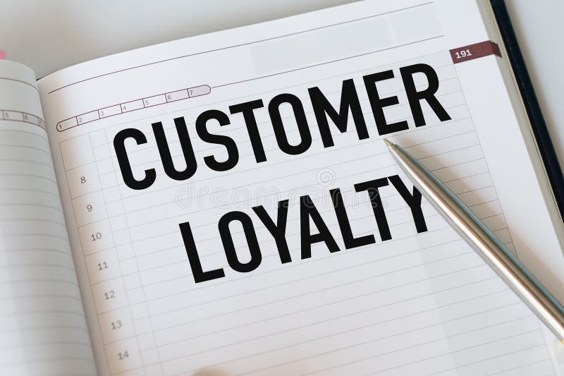 CUSTOMER LOYALTY Text on a Blue Card on a Notebook Next To Reports ...