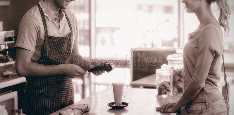 Customer Making Payment through Payment Terminal at Counter Stock Photo ...
