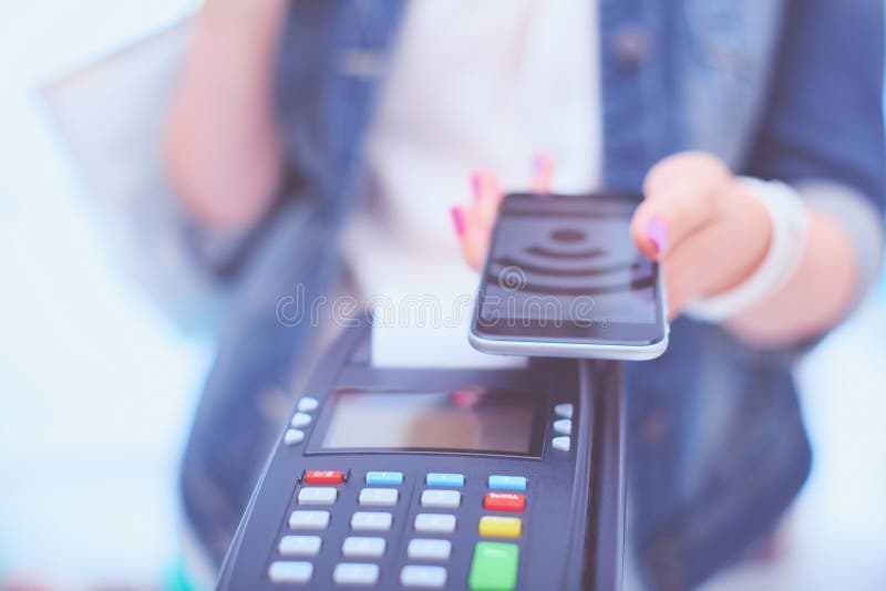 Customer is Paying with Smartphone in Shop Using NFC Technology. NFC ...
