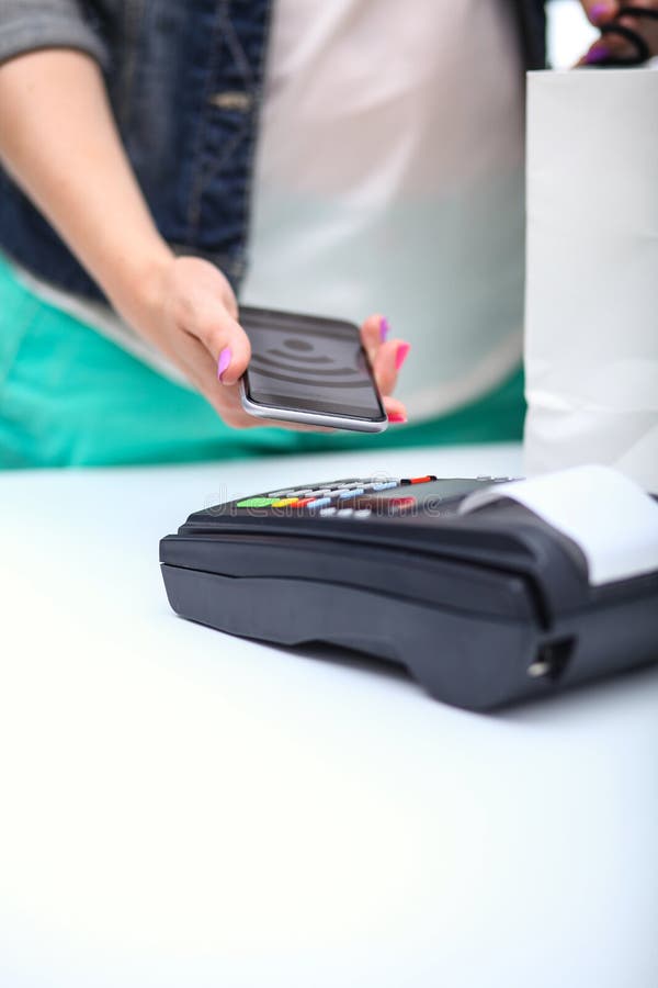 Customer is Paying with Smartphone in Shop Using NFC Technology. NFC ...