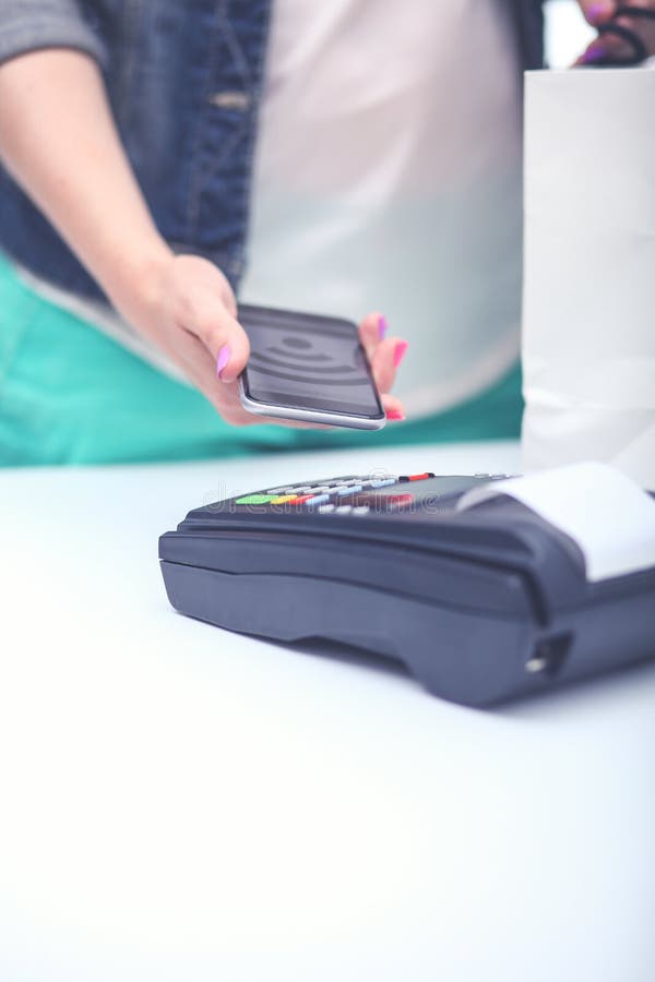 Customer is Paying with Smartphone in Shop Using NFC Technology. NFC ...