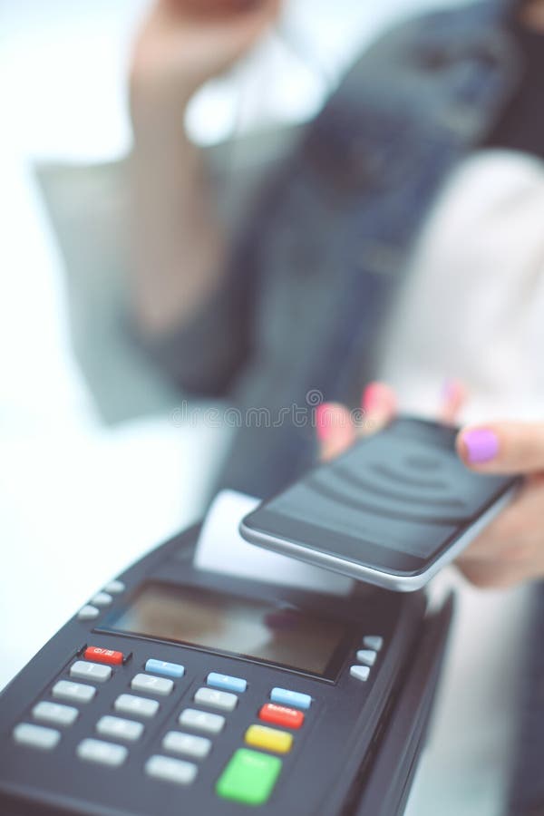 Customer is Paying with Smartphone in Shop Using NFC Technology. NFC ...