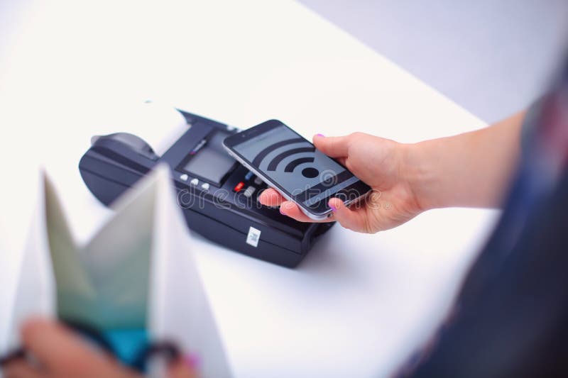 Customer is Paying with Smartphone in Shop Using NFC Technology. NFC ...