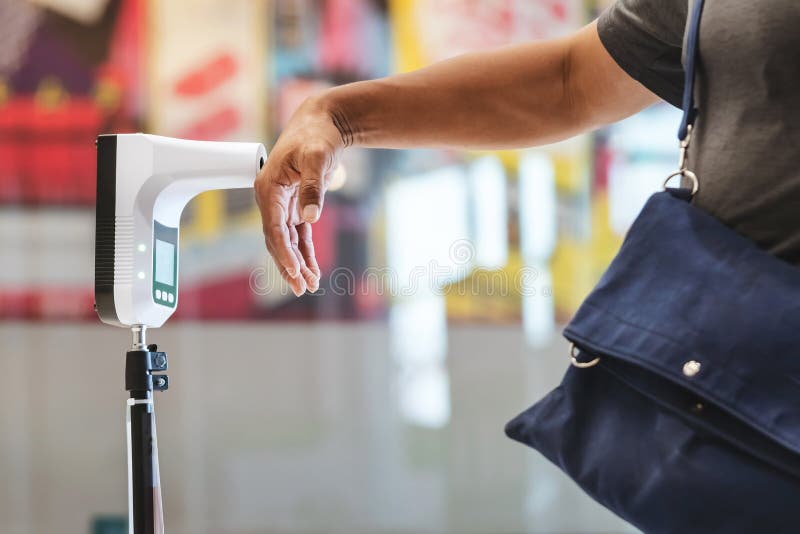 Customer with Protective Mask Raised Hand at Digital Thermometer with ...