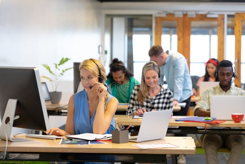 Customer Service Executives Working at Desk in a Modern Office Stock ...