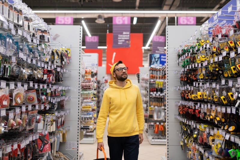 A Customer with a Shopping Basket Wanders Around a Construction ...